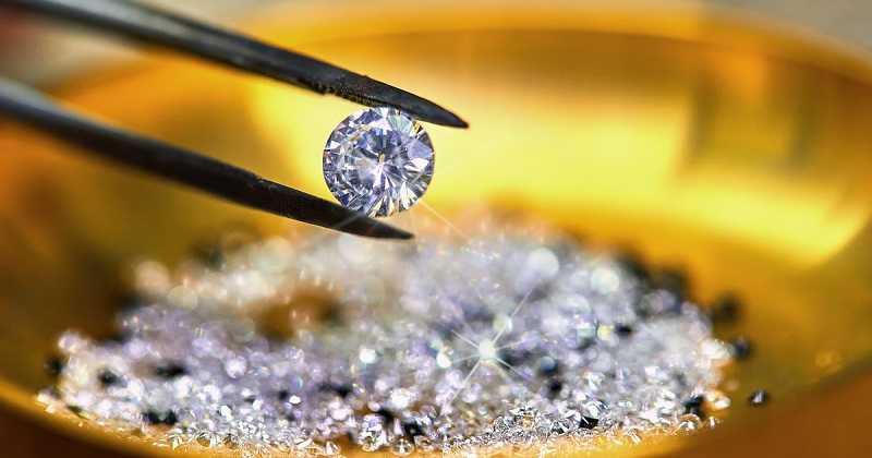 bloombergquint_2024-11-21_wxe8nii7_diamond-held-by-tweezers-against-the ...